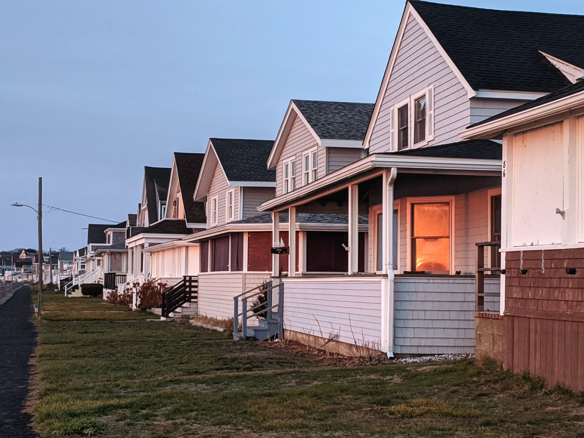 December morning, Long Beach. Sunrise reflections on cottage doors and ...